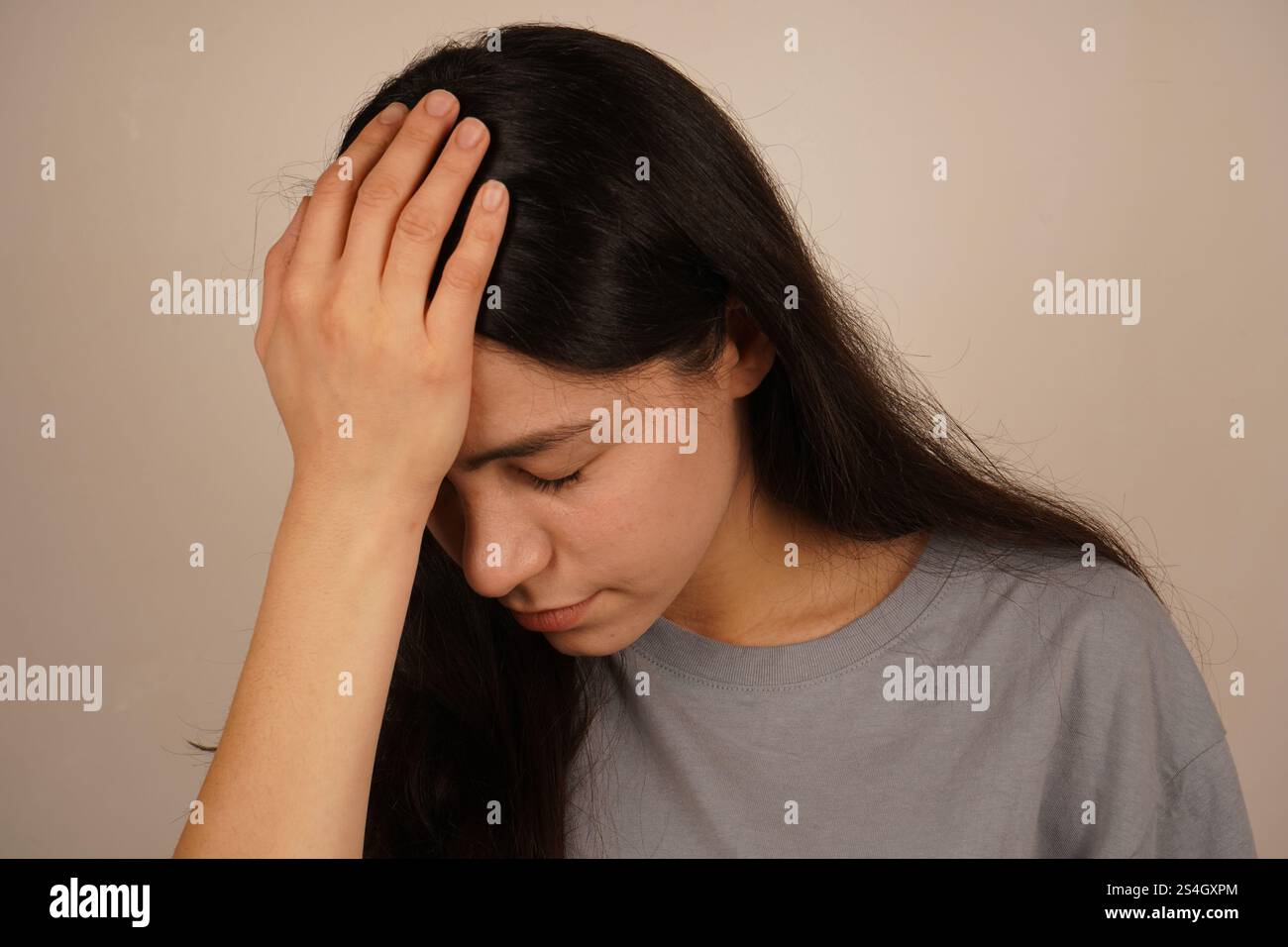 Her posture and expression reflect self-recognition. The photo captures ...