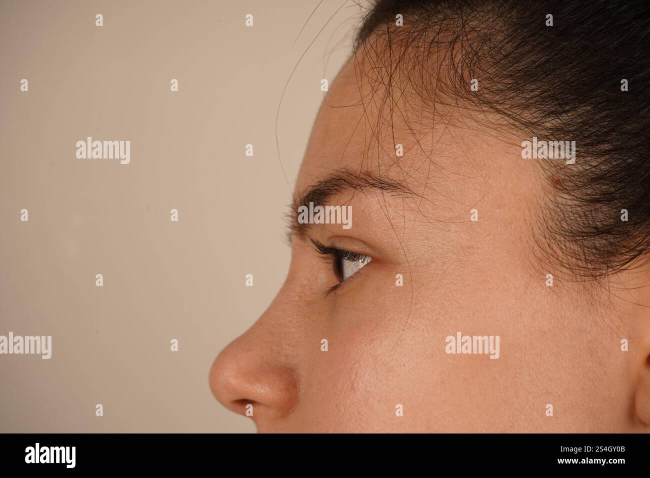 A detailed side view of the girl shows off her dark hair. The ...