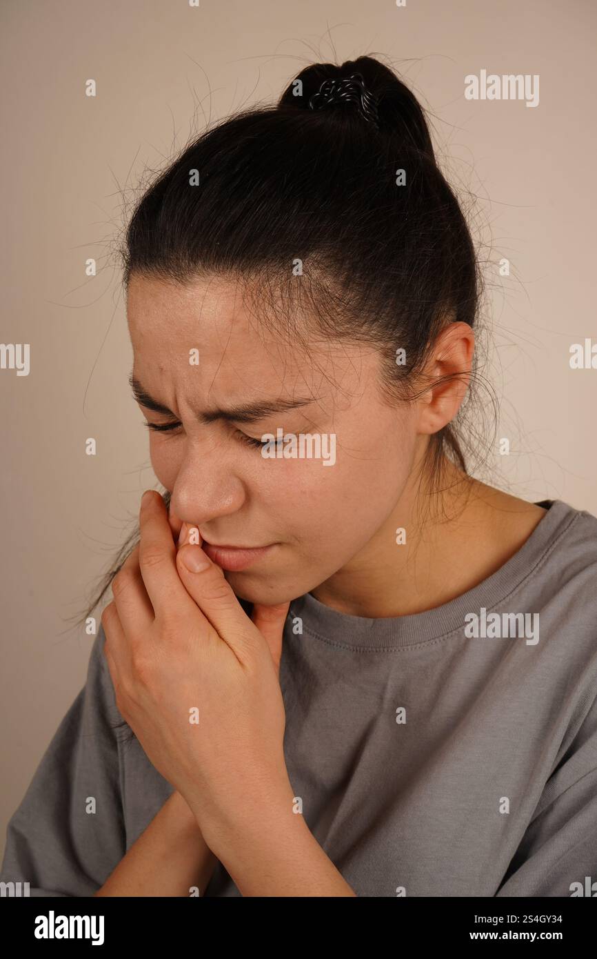 Her body language reflects physical discomfort. The moment is a genuine ...