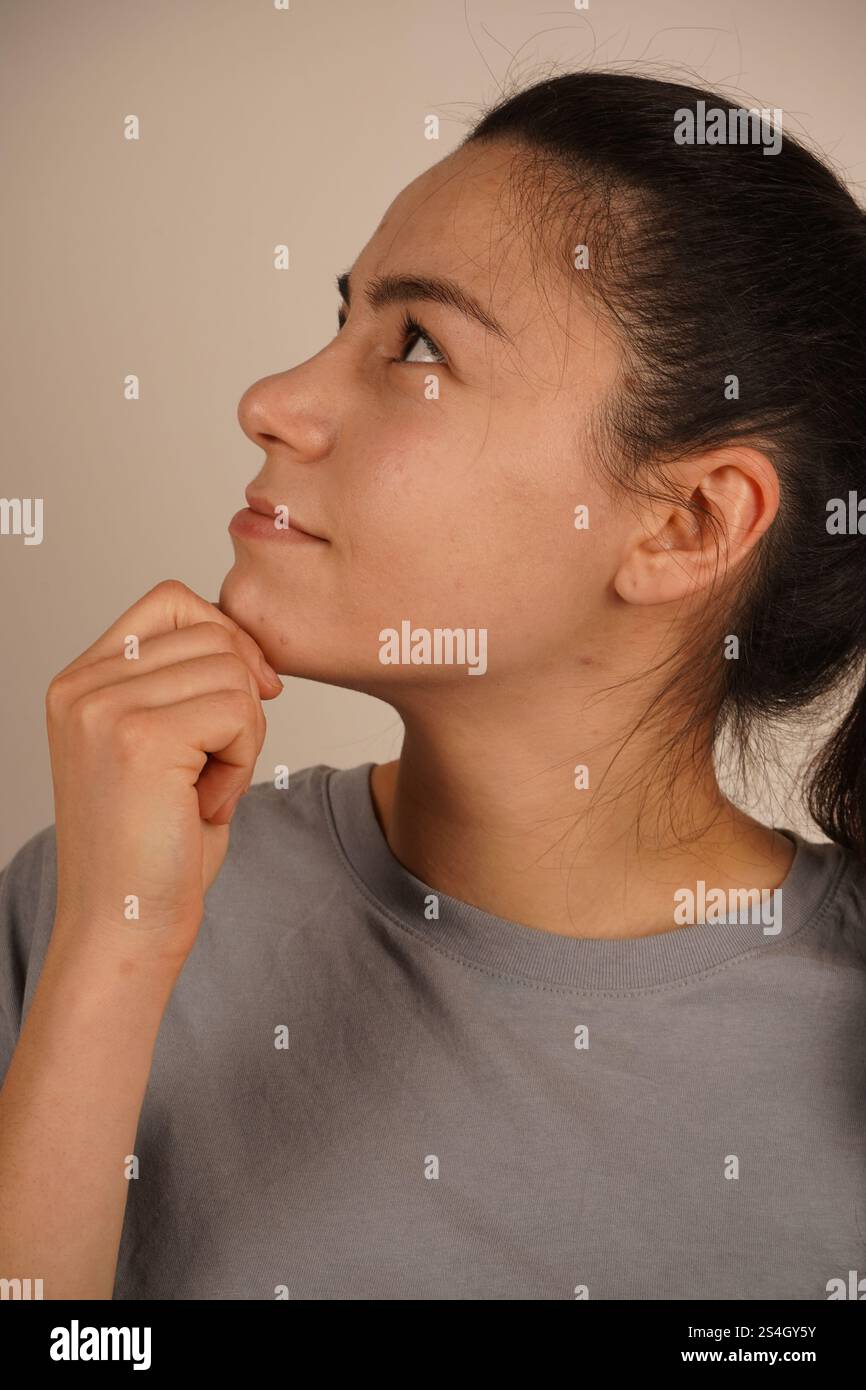 Her thoughtful expression conveys curiosity and quiet pondering. This ...