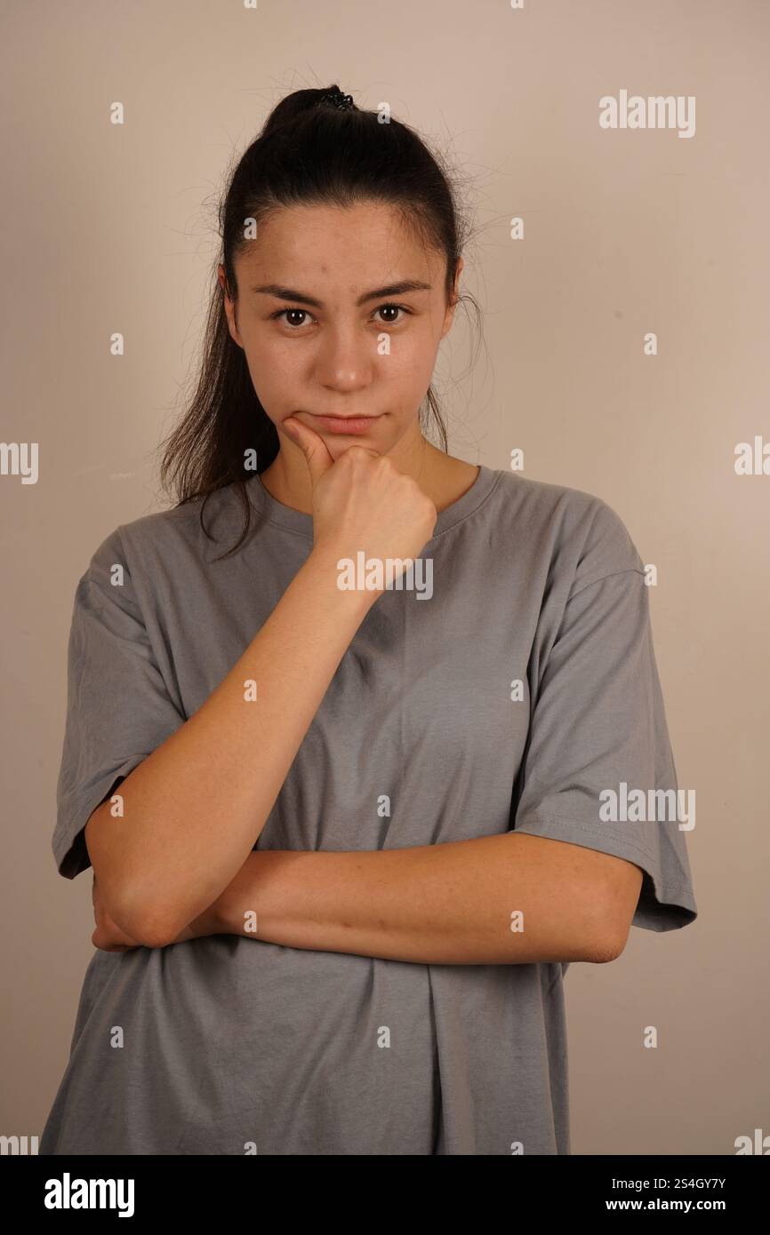 Her gaze is focused, reflecting contemplation and introspection. A calm ...