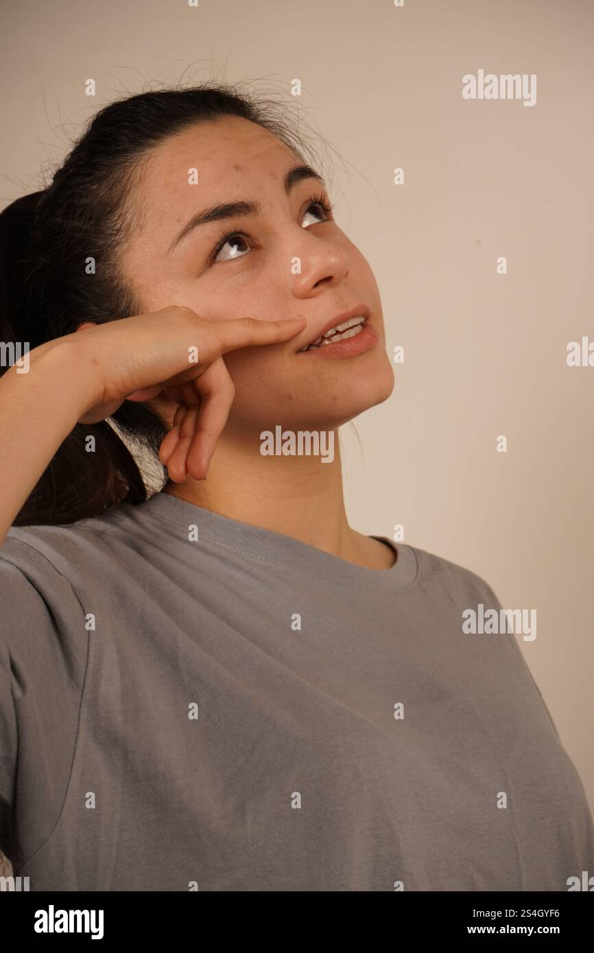 This playful gesture embodies a call for attention or interaction. A ...