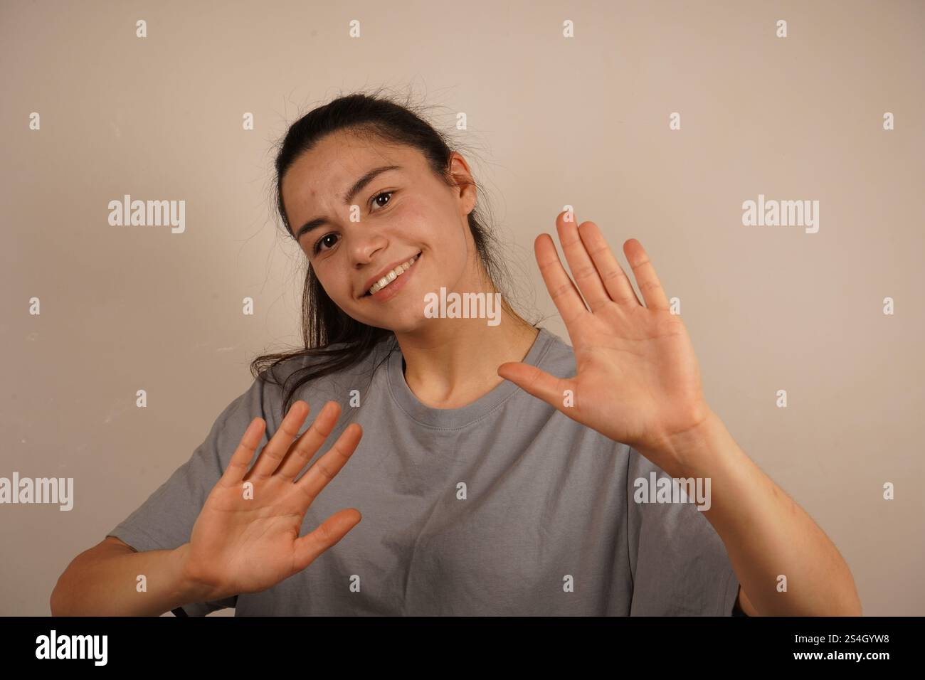 A moment of rejuvenation and release. Both arms are raised high in a ...