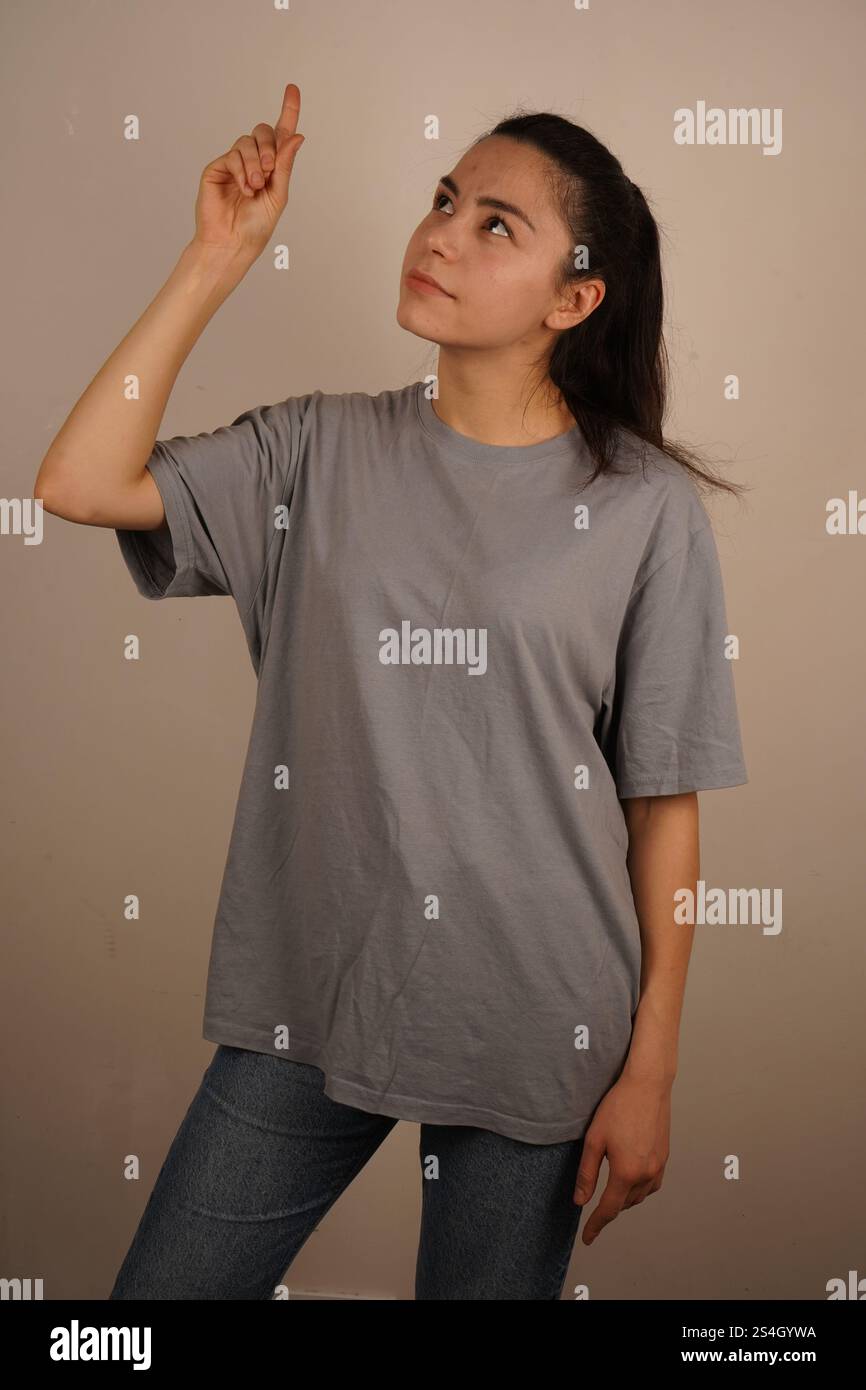 The gesture conveys creativity, focus, and a spark of inspiration. A ...