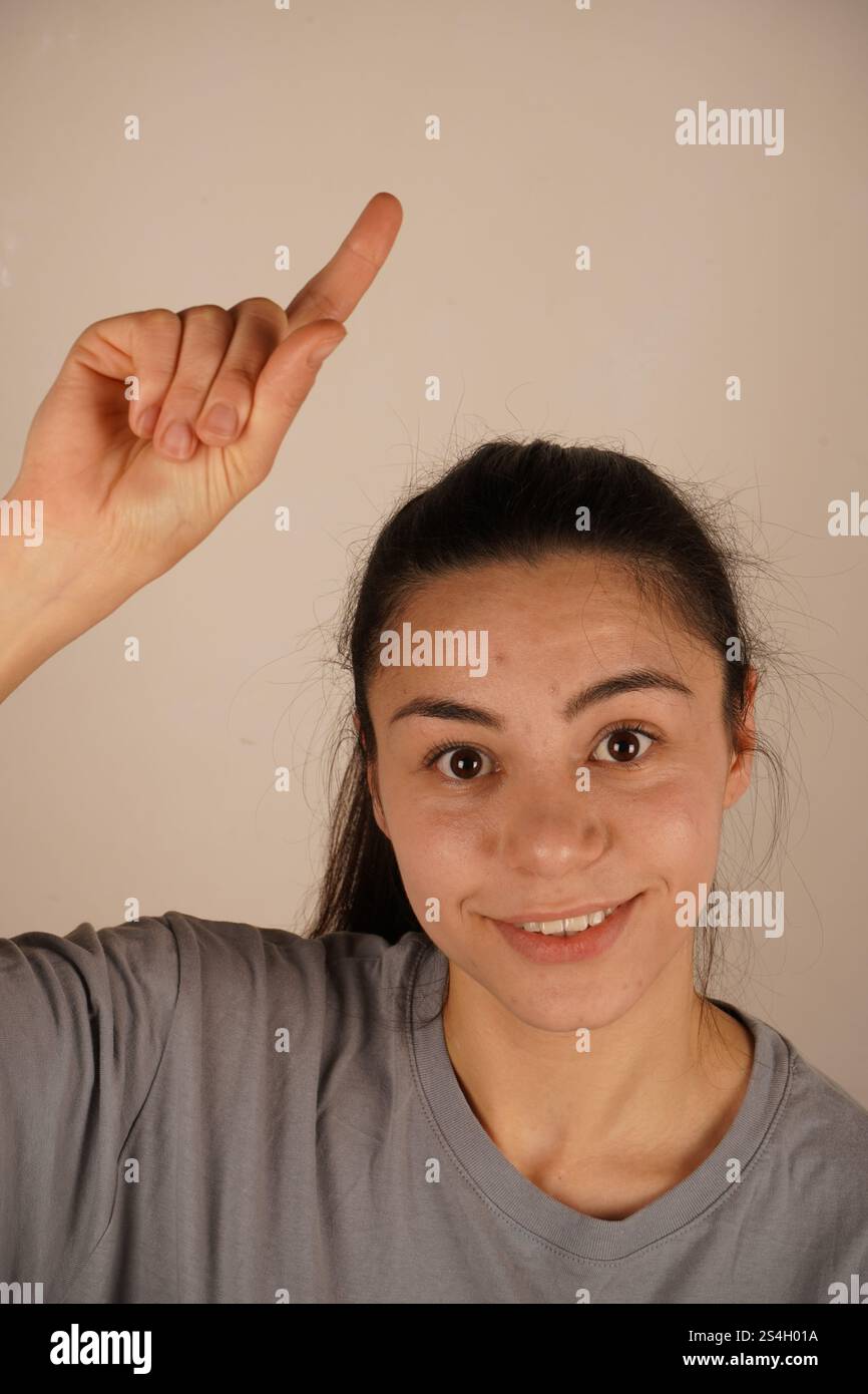 A raised index finger signals the birth of an idea, drawing attention ...