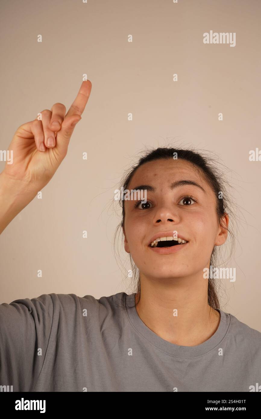 The lifted index finger highlights the emergence of an idea ...