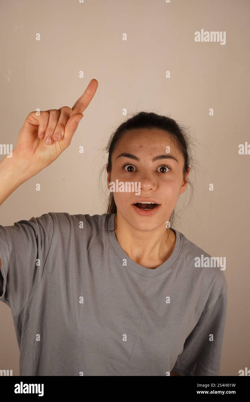 The gesture conveys creativity, focus, and a spark of inspiration. A ...