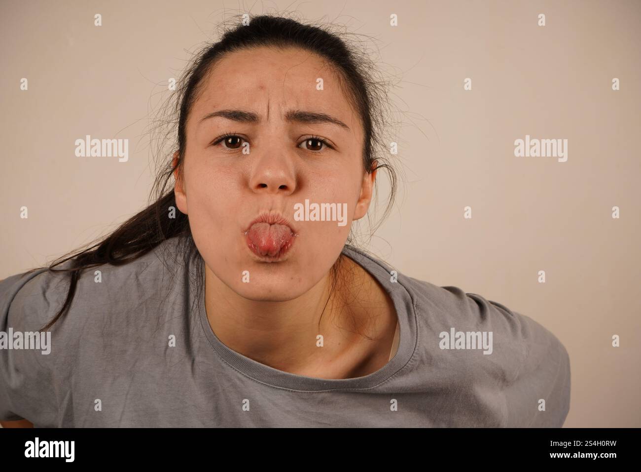 Her face is full of fun, capturing a light and humorous moment. It is a ...