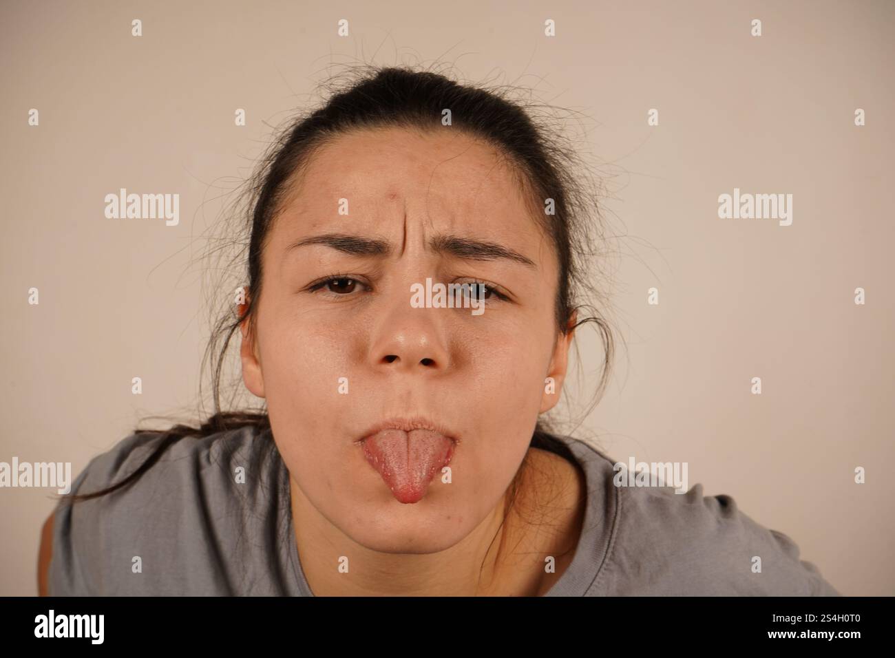 It is a fun and playful reaction. With a playful expression, the girl ...