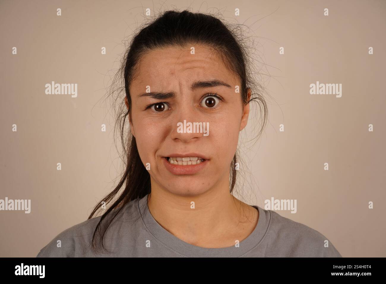 Her face shows a typical reaction to something harsh or surprising ...