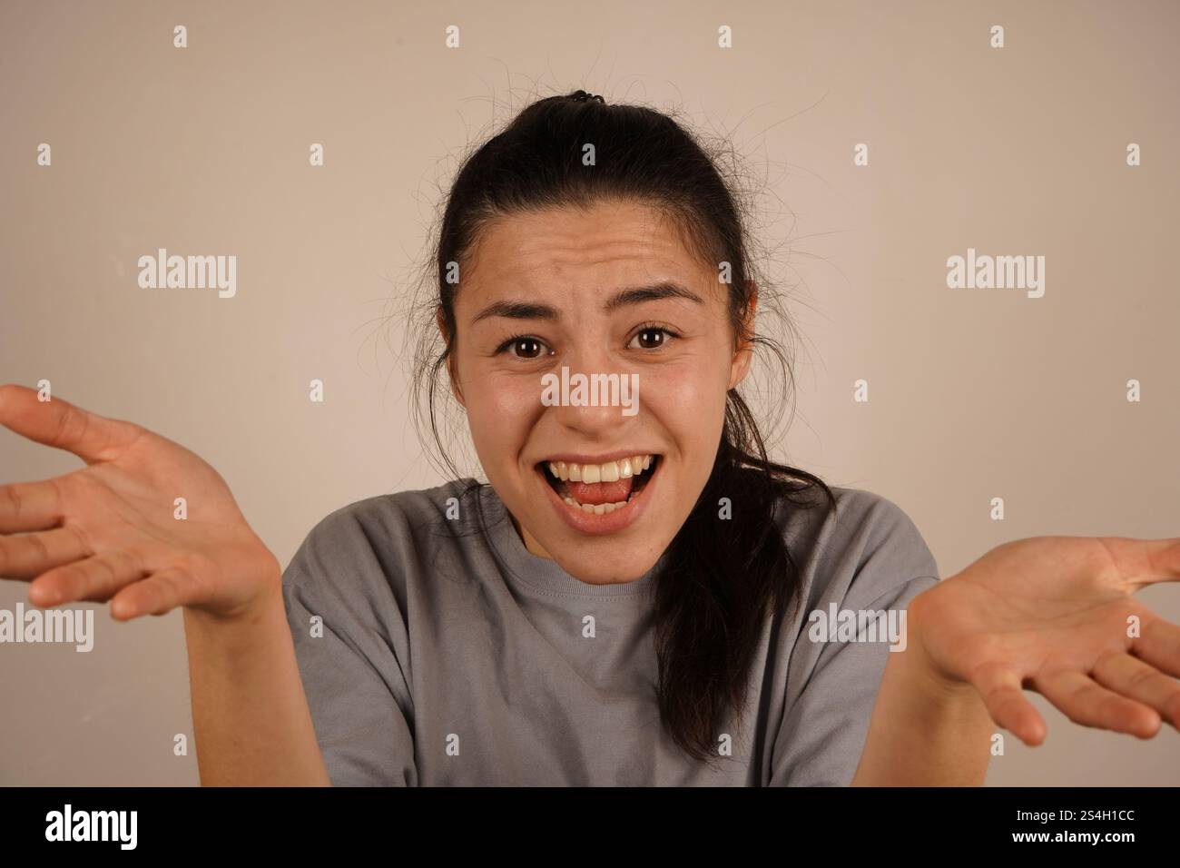 Her bewildered body expression reveals uncertainty. The gesture ...