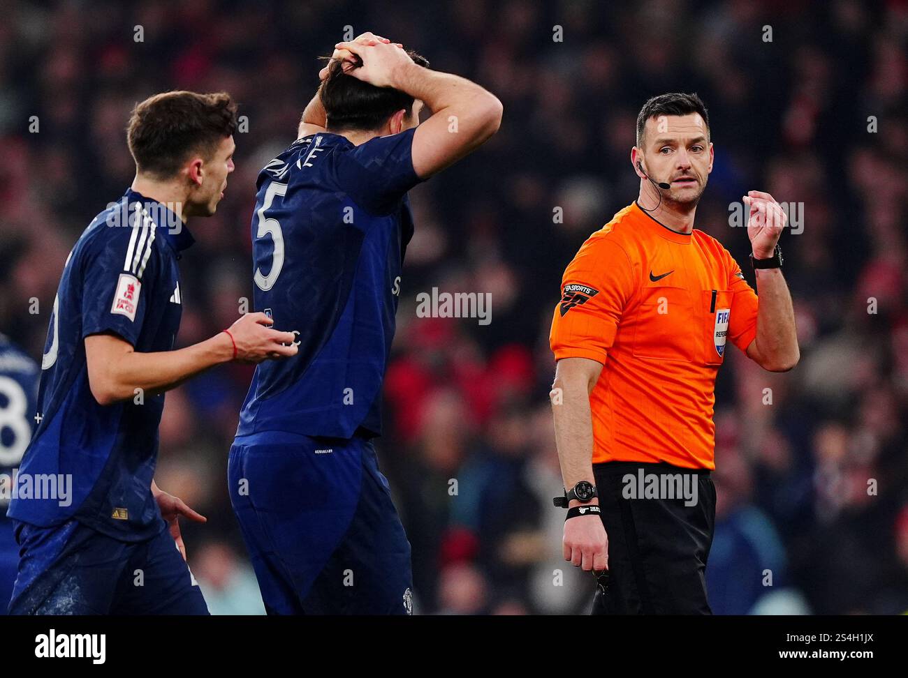 Referee Andrew Madley (right) awards a penalty to Arsenal after ...