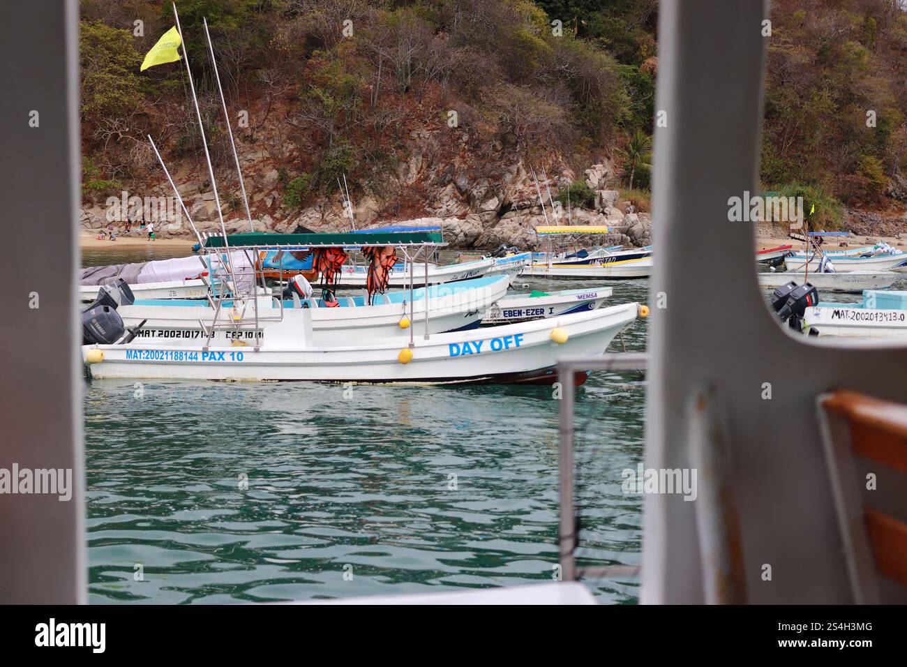 Boats are seen in La India beach part of the bay of Cacaluta, part of ...