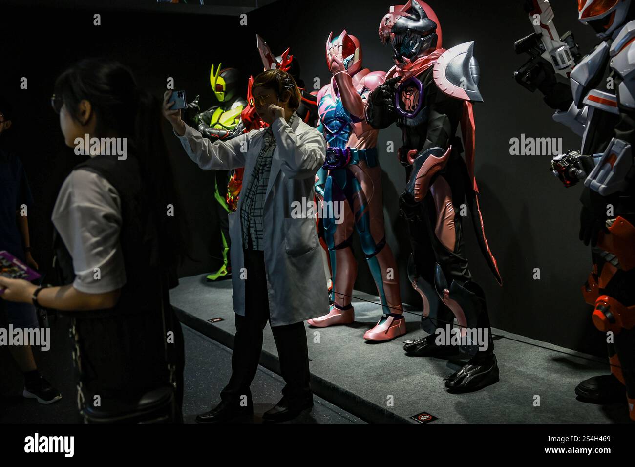 A fan of the Kamen Rider drama series takes a selfie with the Kamen ...