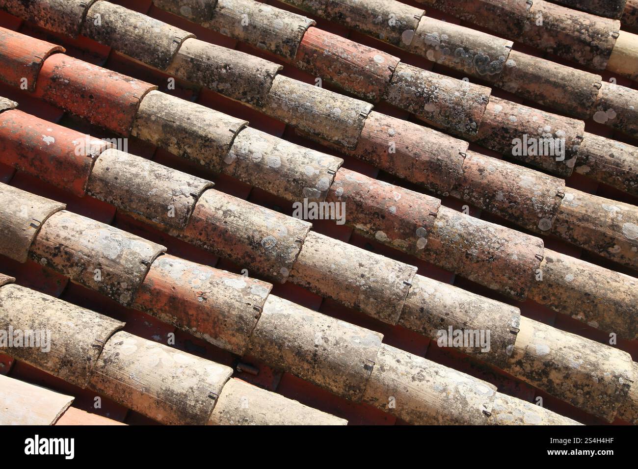 Old clay roof tiles display a unique arrangement and weathering effects ...