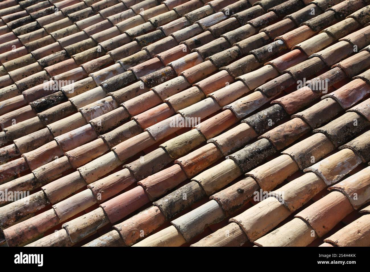 Old clay roof tiles display a unique arrangement and weathering effects ...