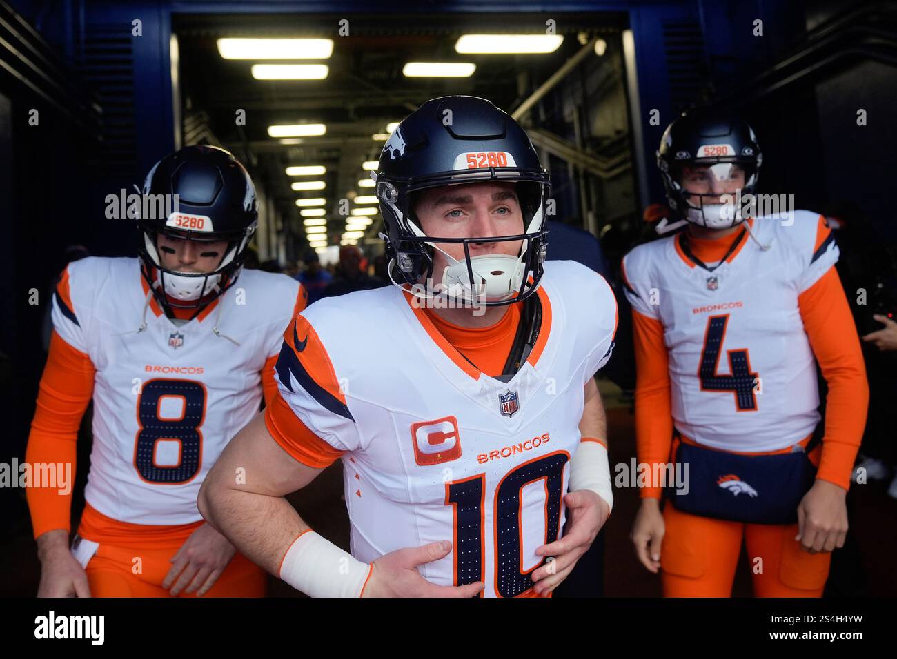 Denver Broncos quarterback Bo Nix (10) prepares to take the field with quarterback Jarrett ...