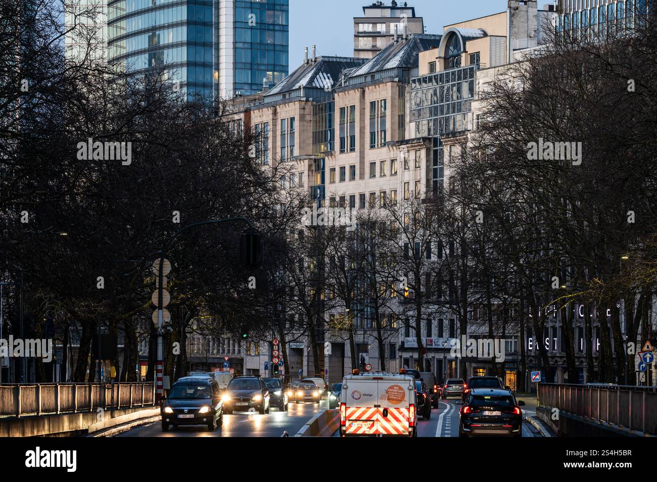 Avenue des Arts with the Astro tower, office buildings and traffic of R20 at dusk in Brussels ...