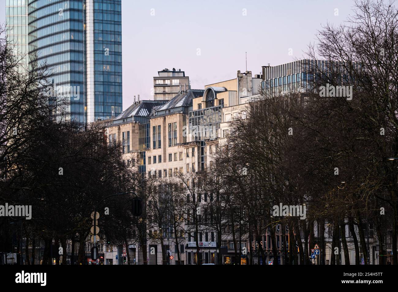 Avenue des Arts with the Astro tower, office buildings and commerce at dusk in Brussels city ...