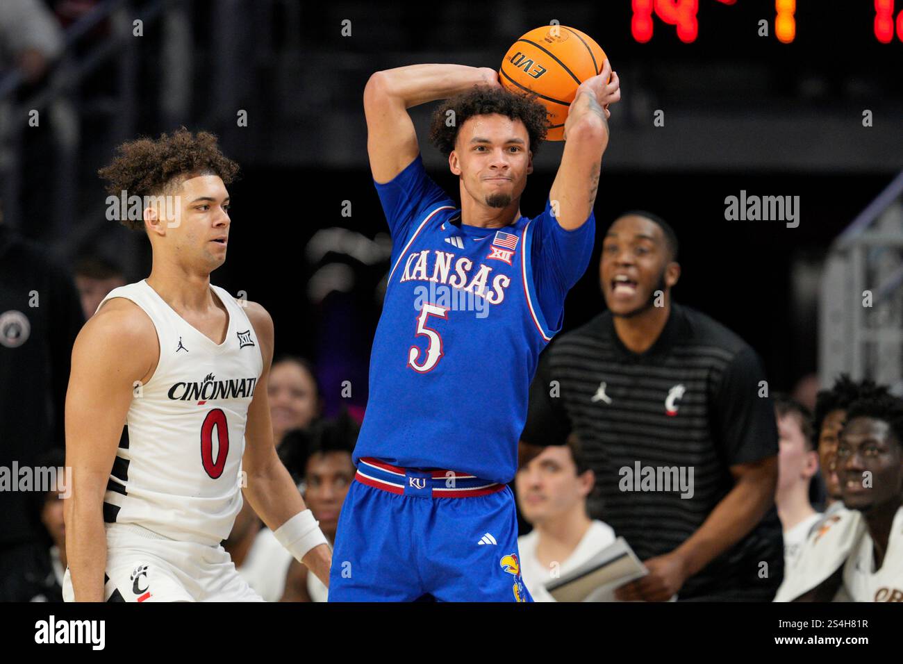 Kansas guard Zeke Mayo (5) looks to pass against Cincinnati guard Dan ...