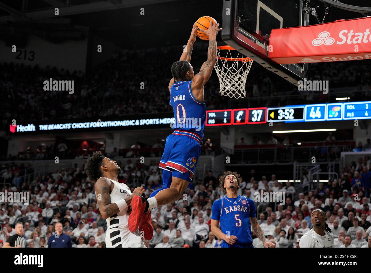 Kansas guard Shakeel Moore (0) dunks during an NCAA college basketball ...