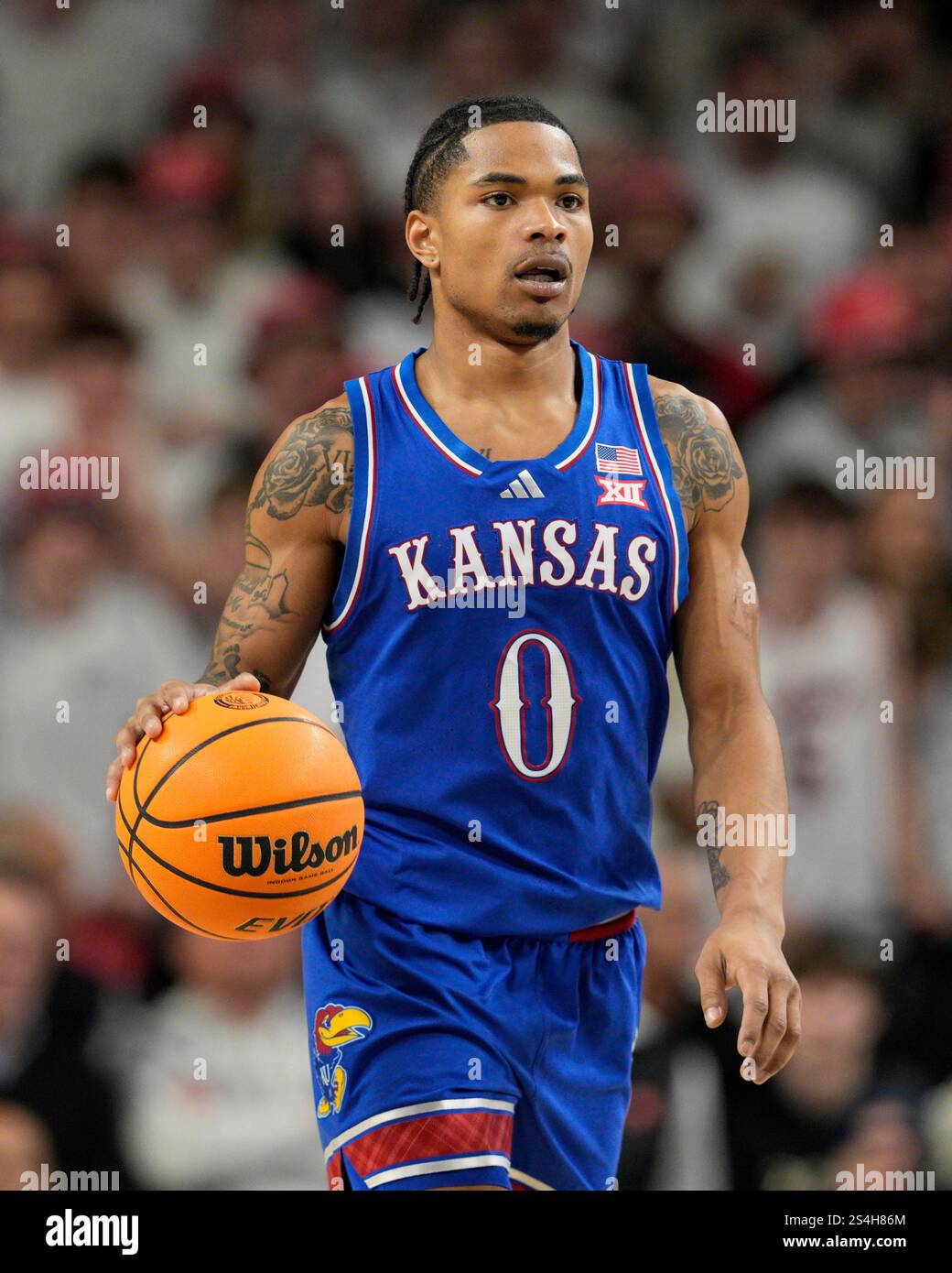 Kansas guard Shakeel Moore (0) dribbles during an NCAA college ...
