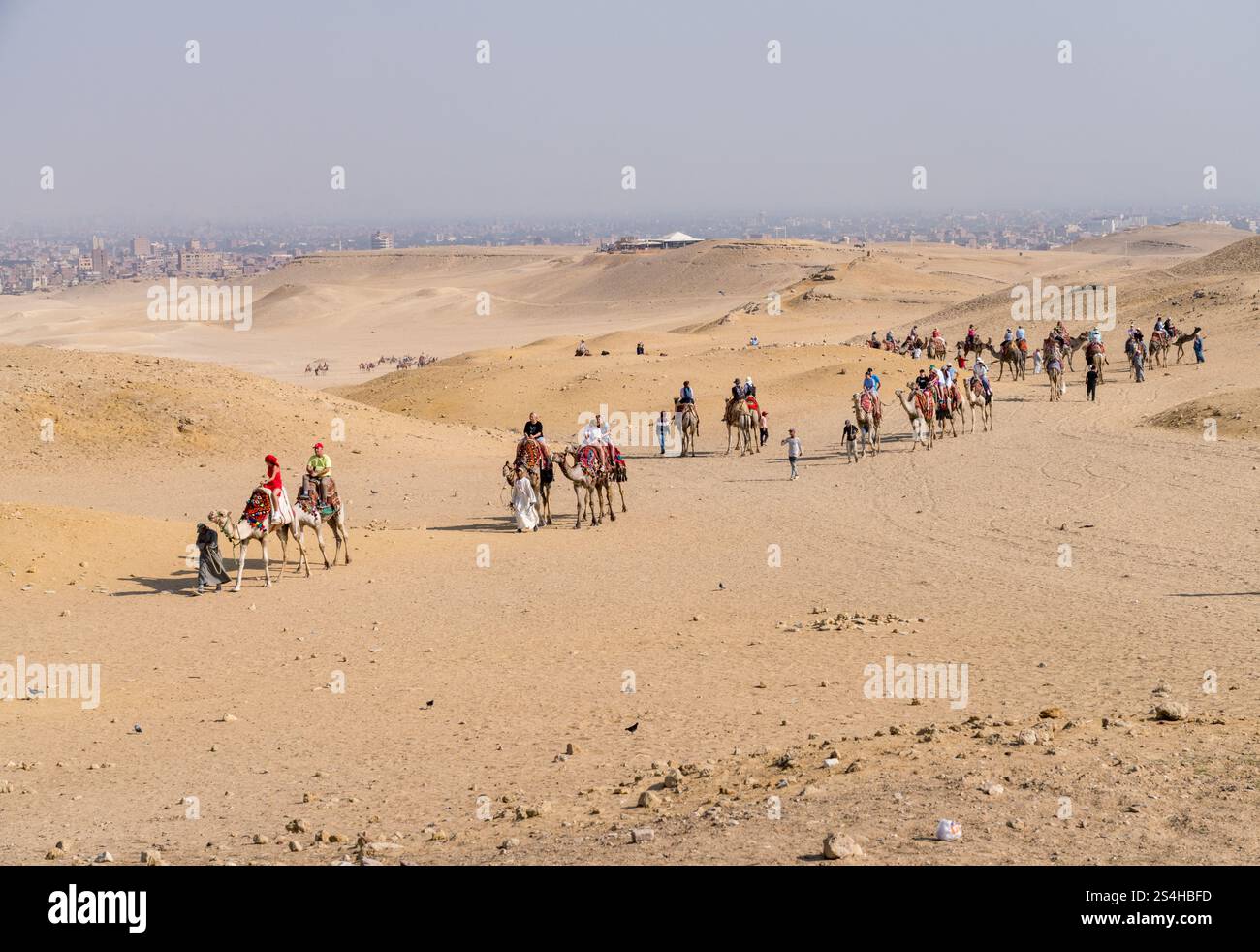 Giza, Egypt - 30 October 2024: Tourists on camel ride in trail across ...