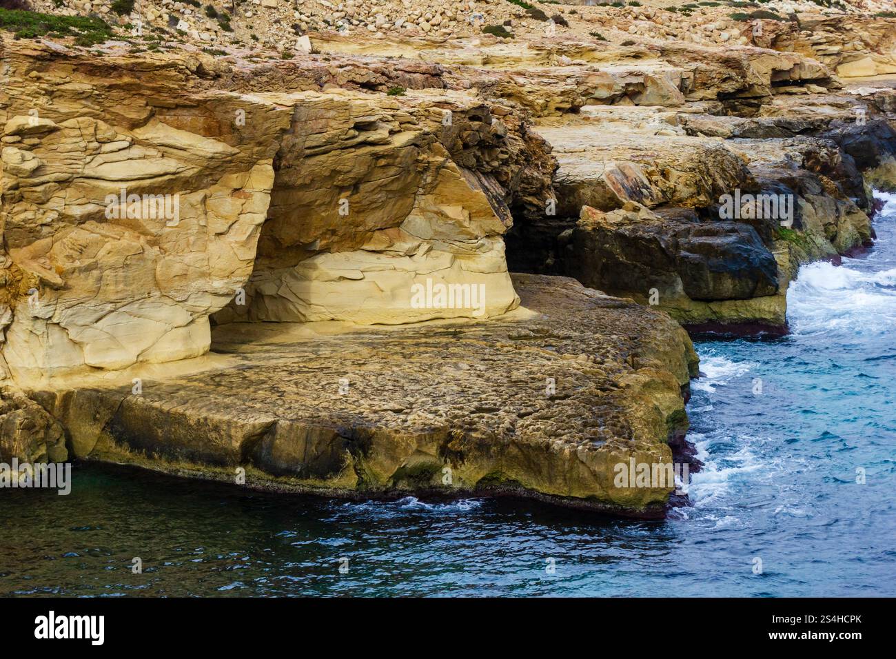 A beautiful coastal cliffside view showcases rocky terrain, lush ...