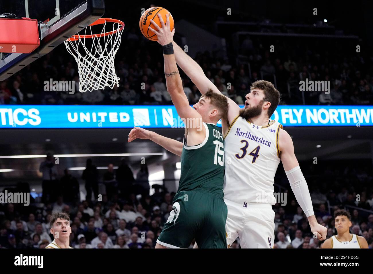 Michigan State center Carson Cooper, left, drives to the basket against ...