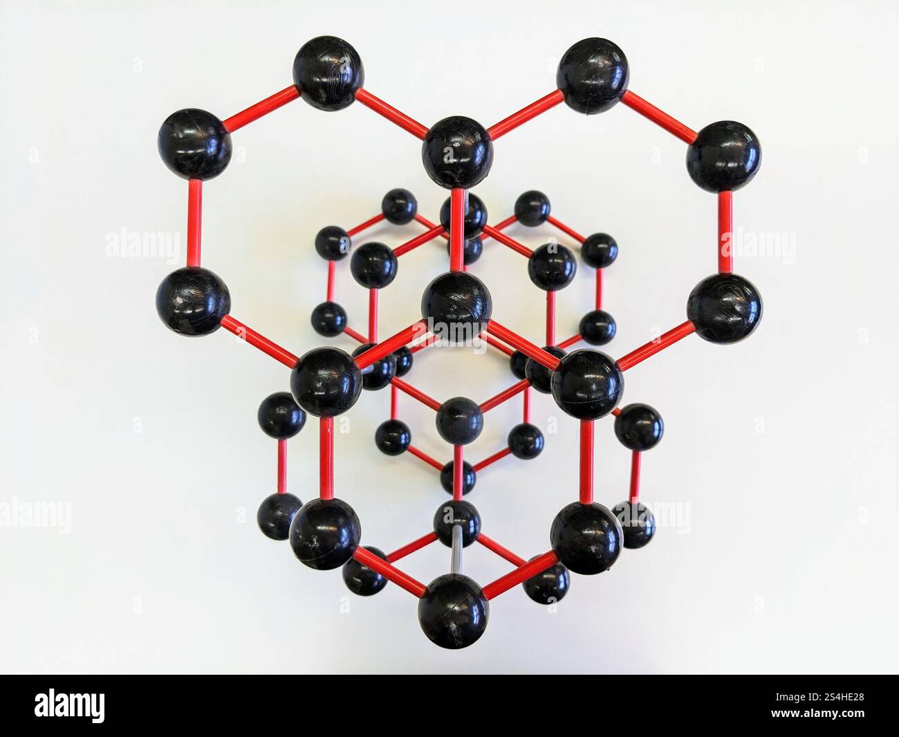 Model of molecule with red and black balls on white surface Stock Photo ...