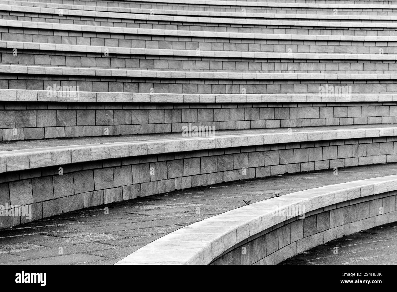 A black-and-white view of a concrete amphitheater's steps, showcases ...