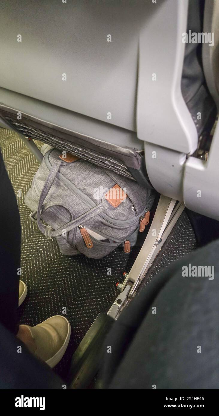 Bag under the seat of an airplane Stock Photo - Alamy