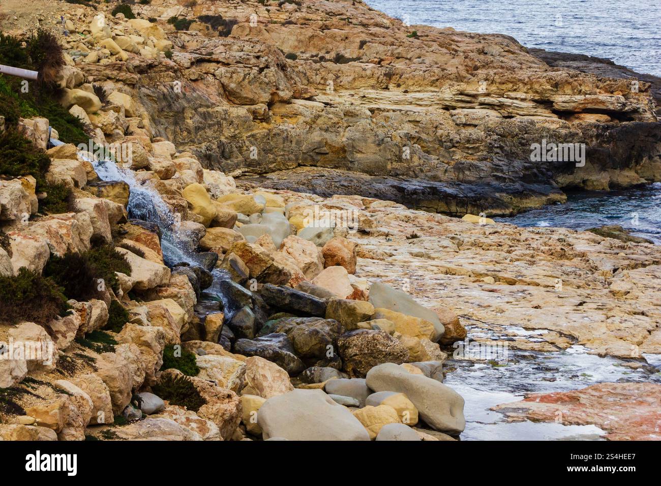 A beautiful coastal cliffside view showcases rocky terrain, lush ...