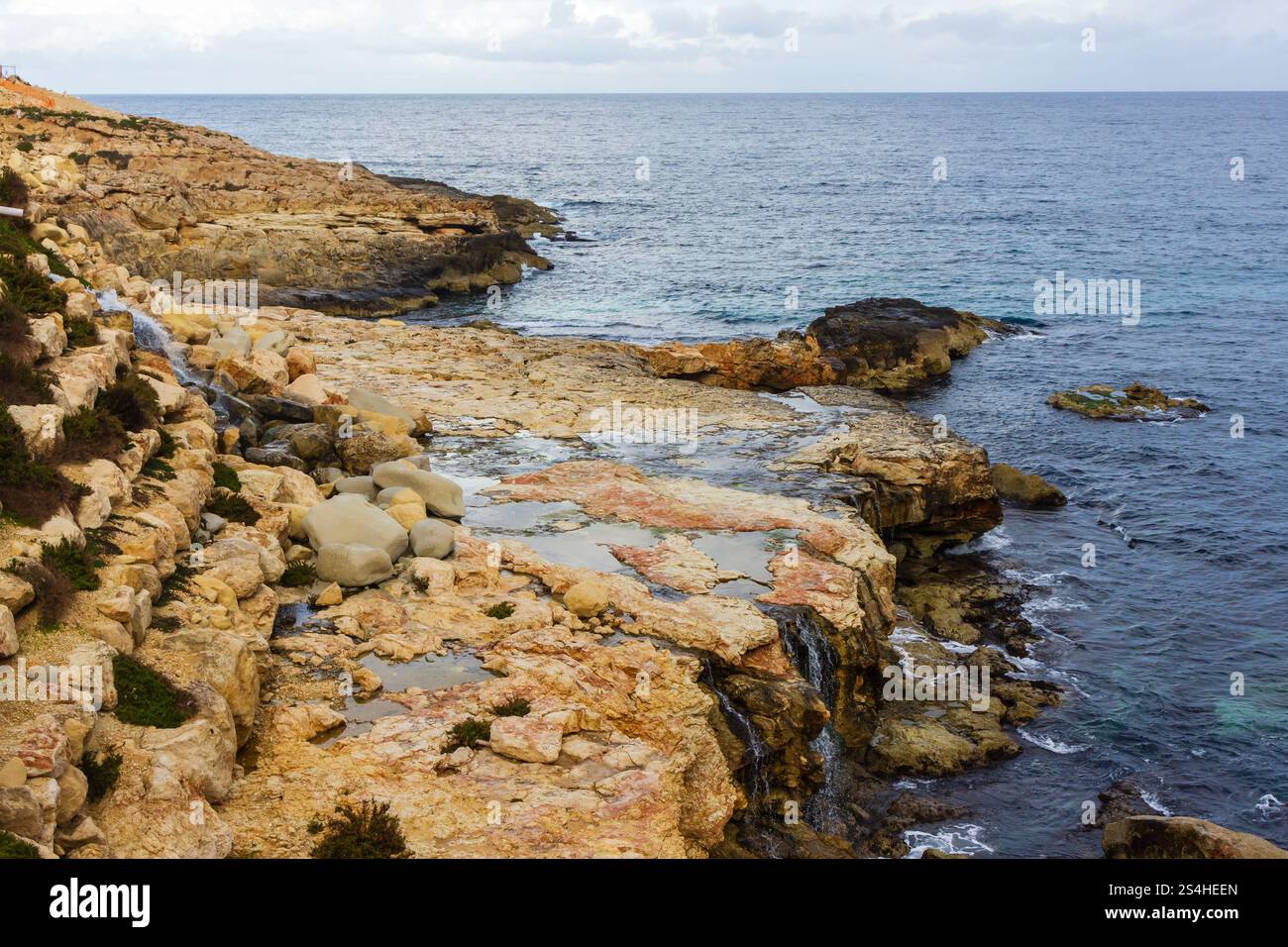 A beautiful coastal cliffside view showcases rocky terrain, lush ...