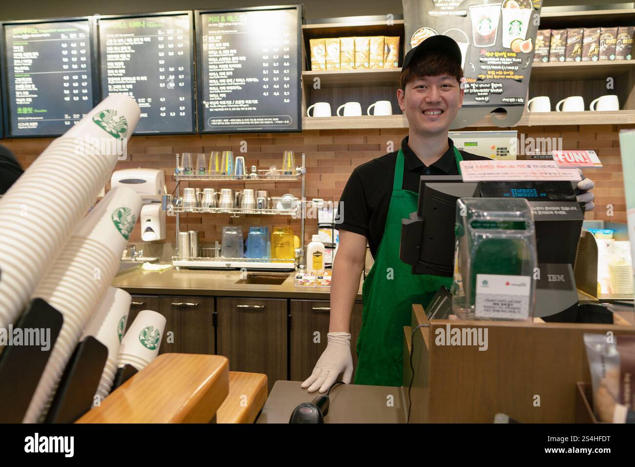 Busan, South Korea - May 27, 2017: a male cashier at the counter in ...