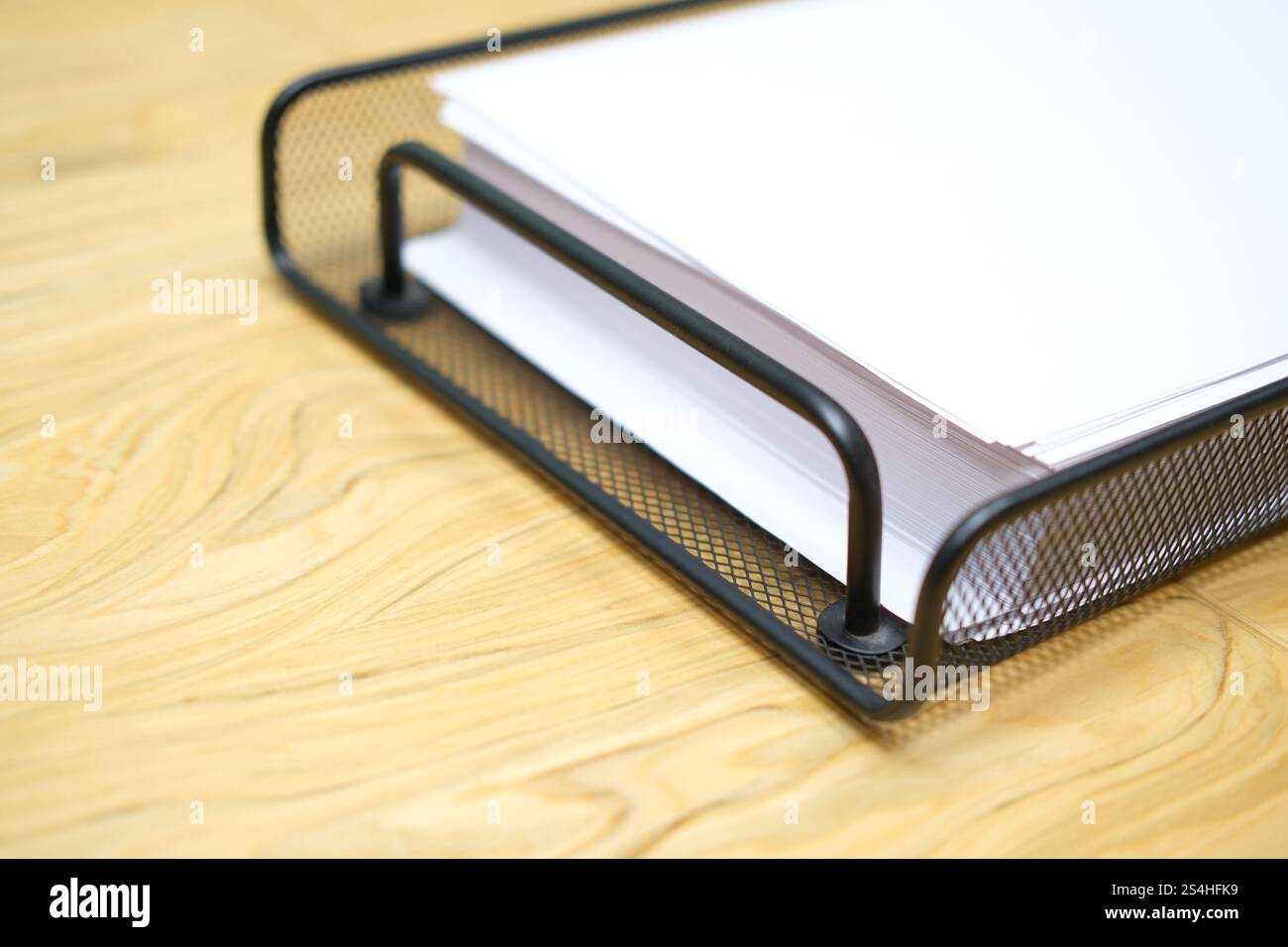 Metal black paper tray with white empty sheets of A4 paper on light ...