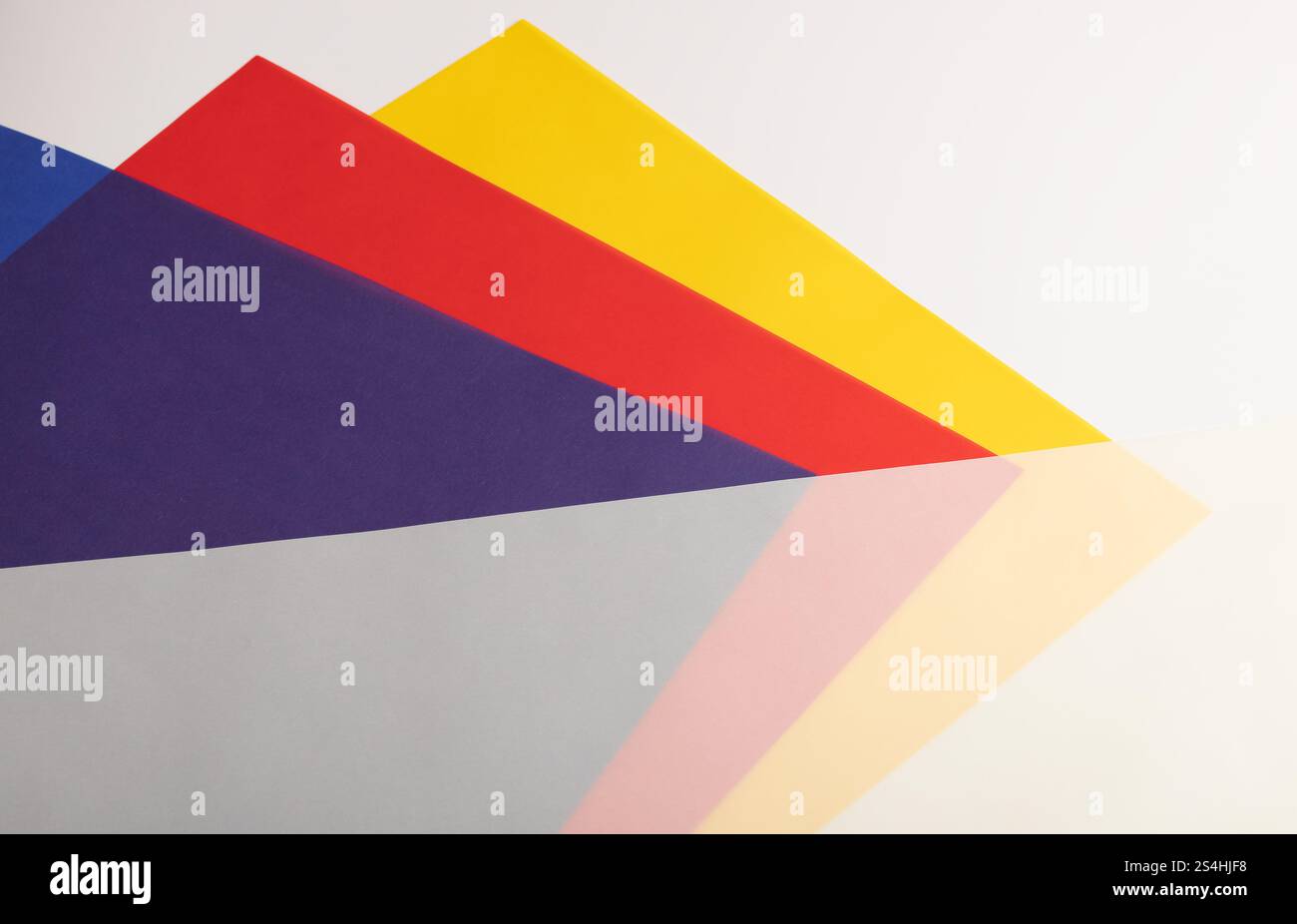Layered paper background with translucent red, yellow, blue, and purple ...