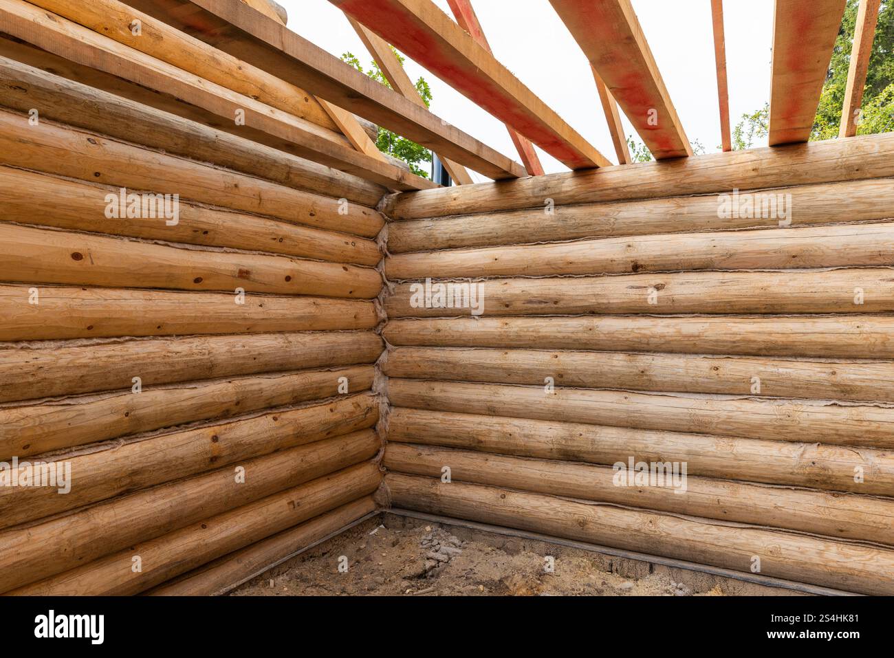 Rural log house is under construction. New wooden house interior ...
