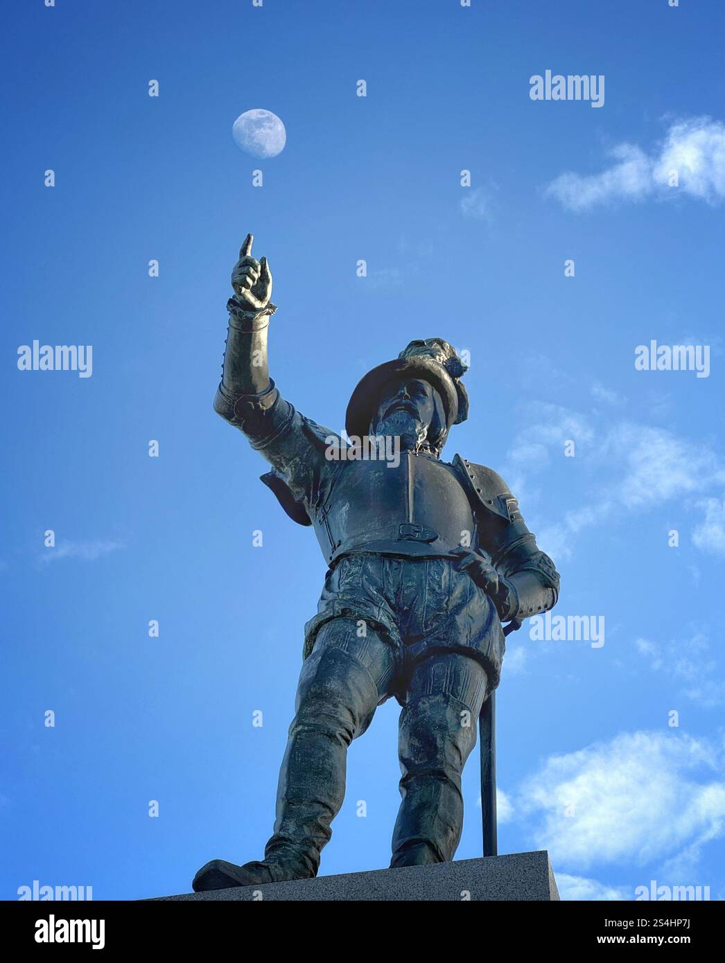 Statue of Ponce de Leon pointing at a waning moon in the sky overhead ...