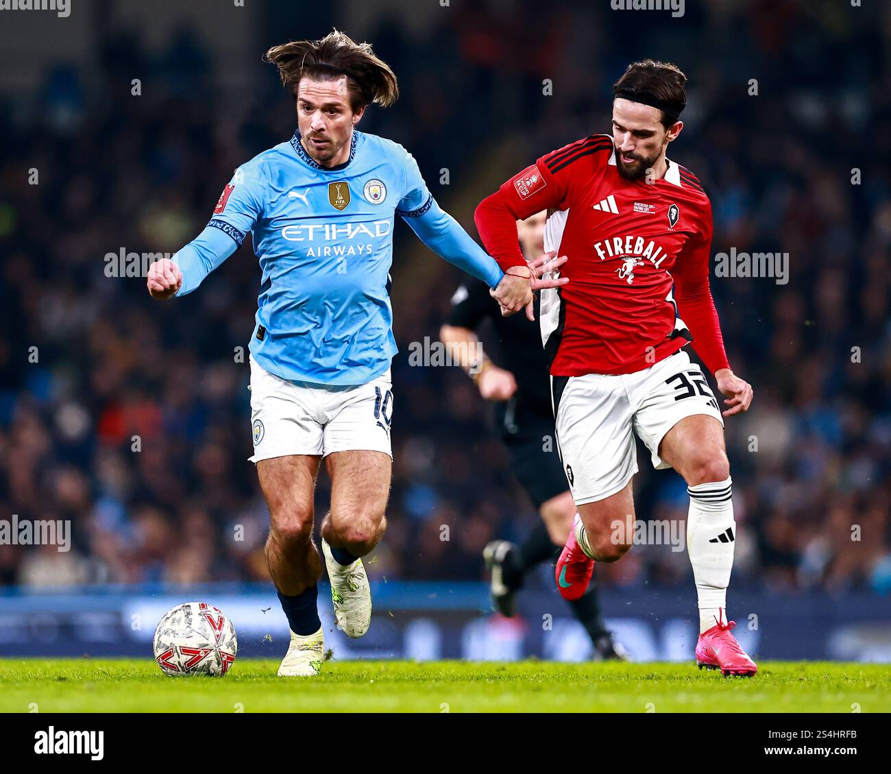 Manchester, UK. 11th Jan, 2025. Liam Shephard of Salford City battles ...