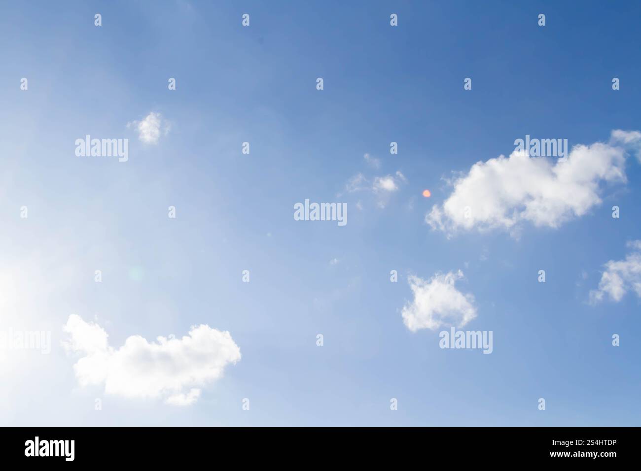 White airy beautiful clouds in a bright blue sky. Clear sunny weather ...