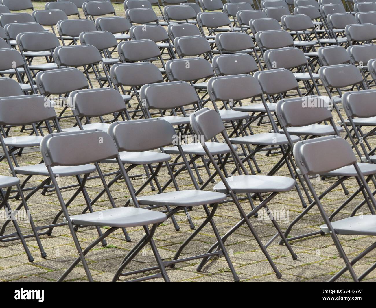 Gray Folding Chairs Arranged In Rows And One Chair At An Angle Stock ...