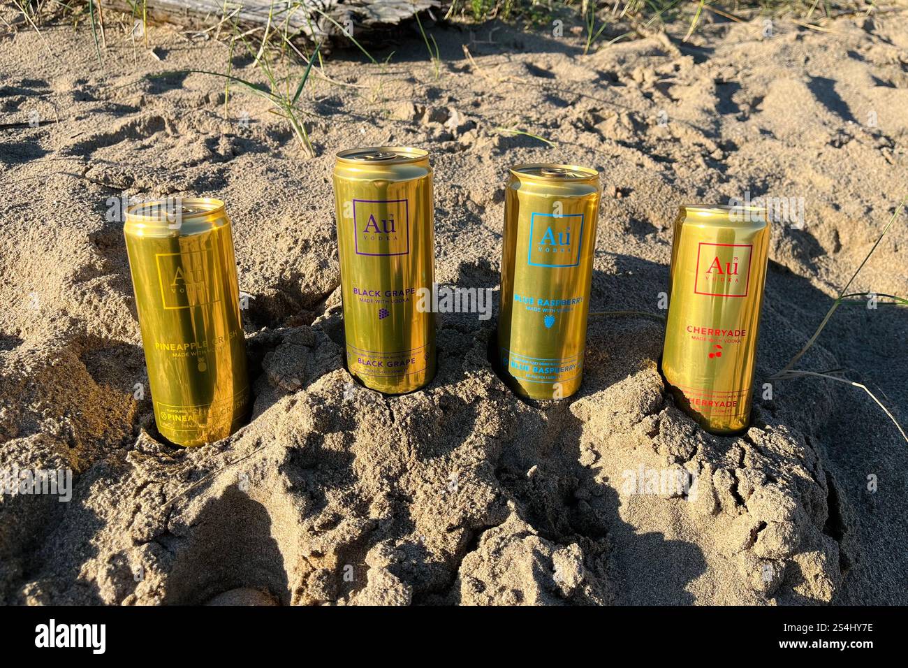 A selection of 330ml Au Vodka Pre-Mixed Cans in the sands of Swansea ...