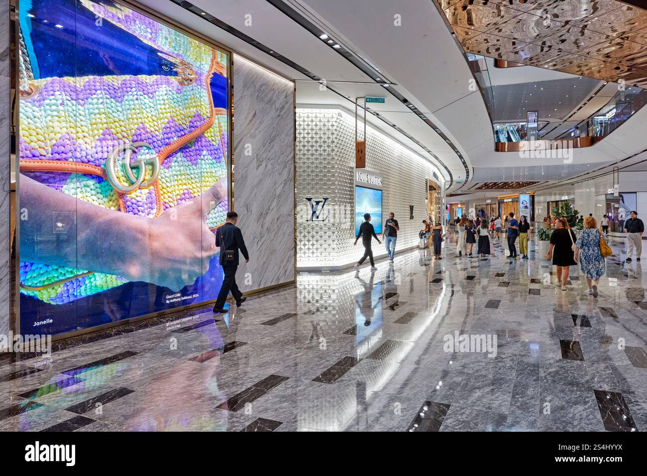 People walk inside the Exchange TRX, an upscale shopping mall in Kuala ...