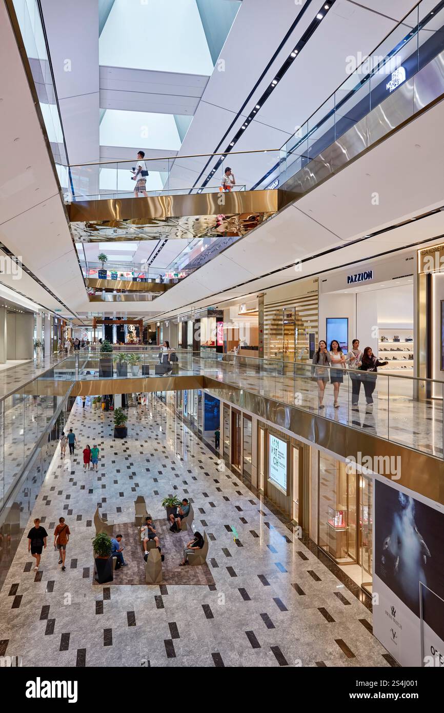 People walk inside Exchange TRX, an upscale shopping mall in Kuala ...