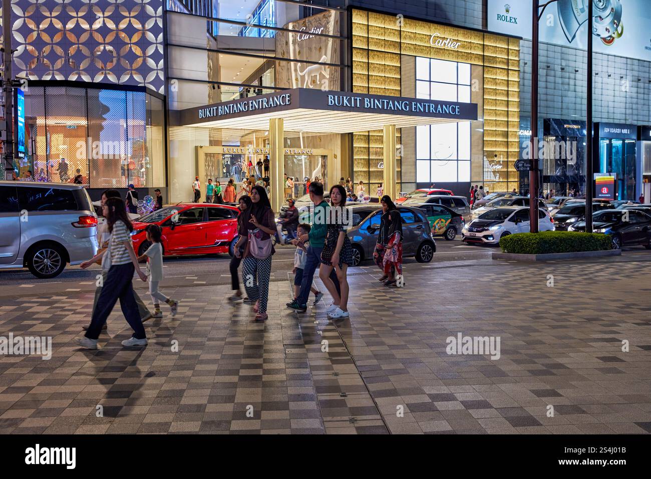 People walk along Jalan Bukit Bintang in front of the Pavilion Shopping ...