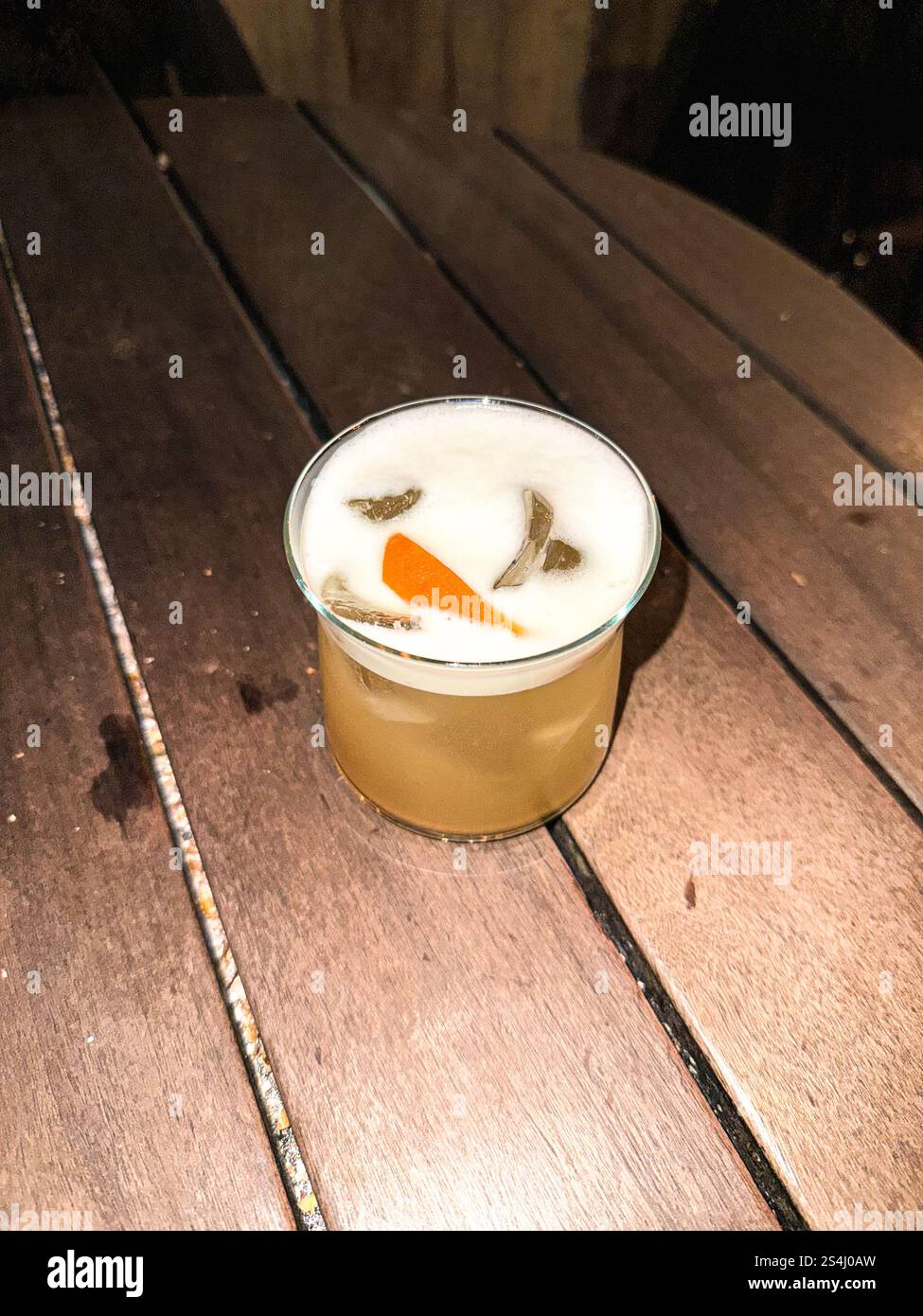 Whiskey Sour cocktail in a round glass on a table. Flashlight Stock ...