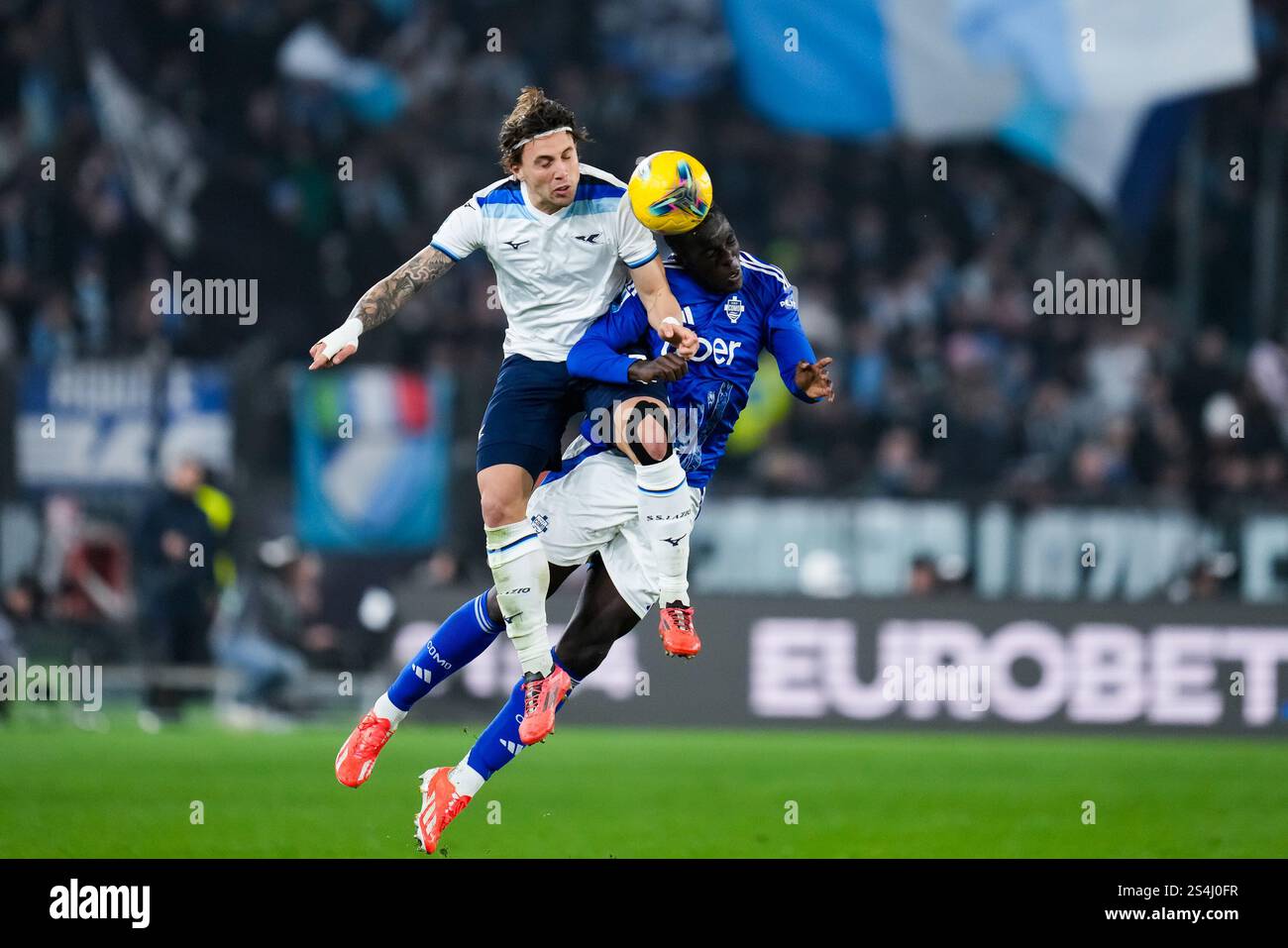 Rome, Italy. 10th Jan, 2025. Assane Diao of Como 1907 and Luca Pellegrini of SS Lazio jump for ...