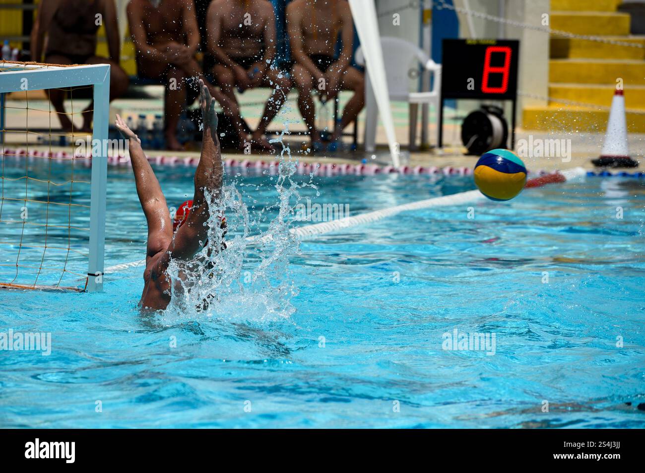 Athletes in swimming pool playing water polo. Aquatic sport ...