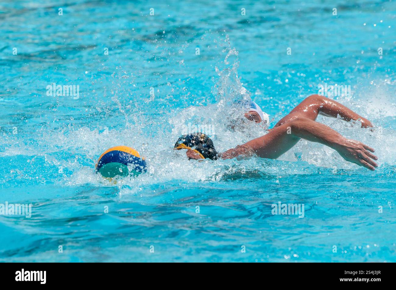 Athletes in swimming pool playing water polo. Aquatic sport ...